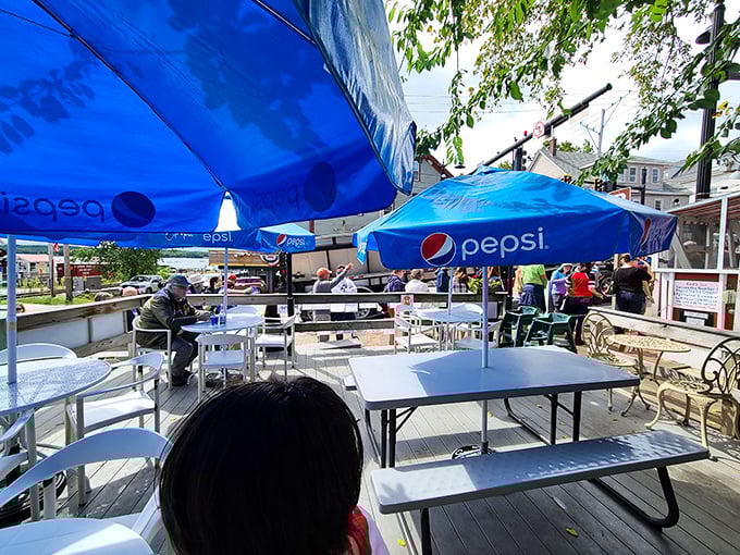 Outdoor seating under Pepsi umbrellas &ndash; the perfect spot to savor your hard-earned seafood treasures.