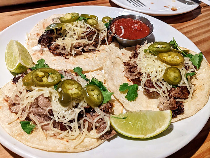 Pork tacos topped with jalape&ntilde;os, cilantro and lime &ndash; three perfect bites of balanced flavor that leave you contemplating ordering another round.