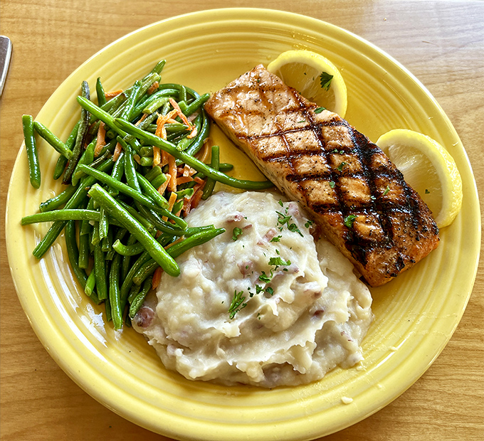 Perfectly grilled salmon with vibrant green beans and creamy mashed potatoes &ndash; proof that The Marina excels at simple, thoughtful preparation of quality ingredients.