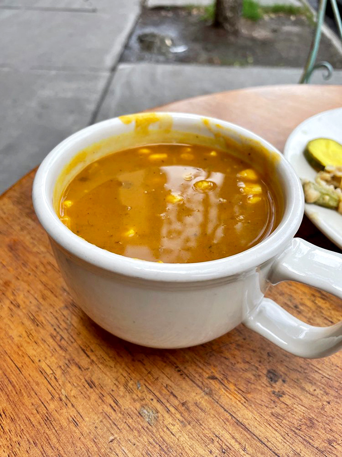 Golden broth studded with sweet corn kernels &ndash; this soup exemplifies why the caf&eacute; earned its name and loyal following.