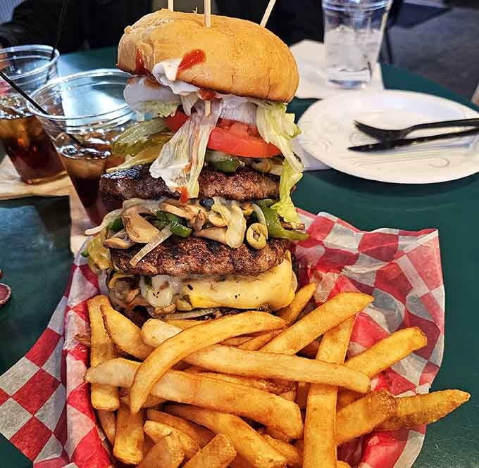 The triple burger towers like an edible skyscraper, challenging both your jaw capacity and your commitment to finishing what you started.