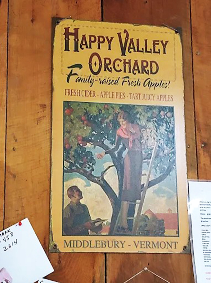 Vintage signage celebrates the orchard's heritage, depicting the timeless tradition of apple harvesting that connects modern visitors to agricultural history.