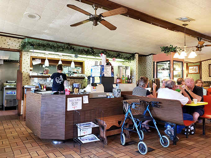 The cozy interior welcomes diners with nostalgic red booths and floral wallpaper, creating an atmosphere where time slows down and conversations flow.