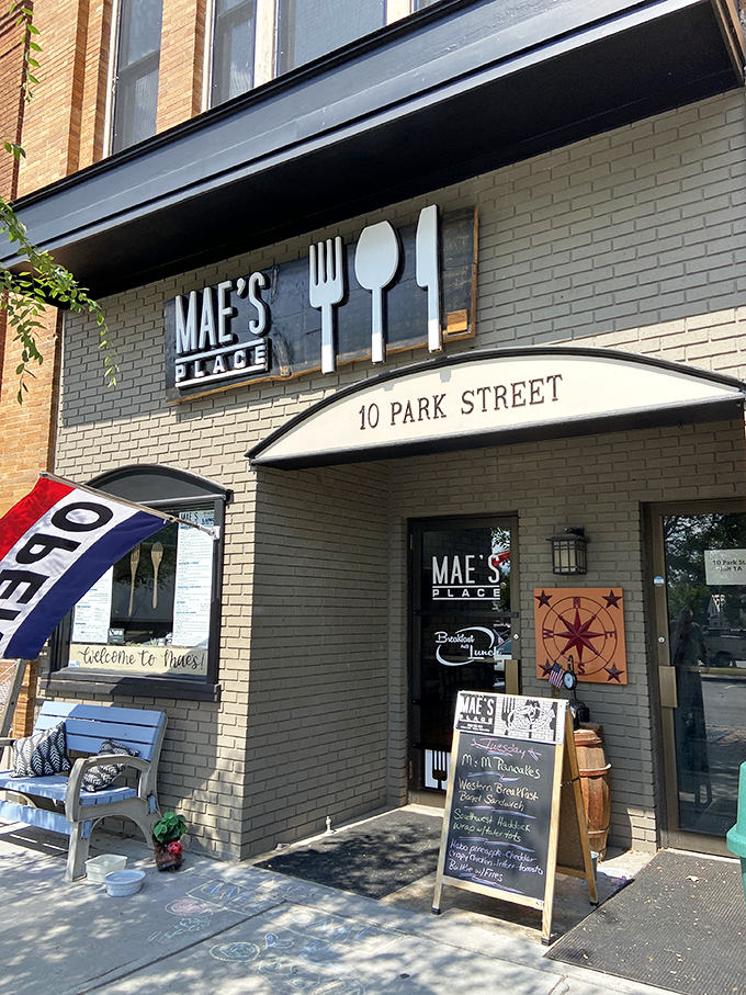 Welcome to breakfast paradise! Mae's Place beckons with its charming brick facade and promise of culinary delights.