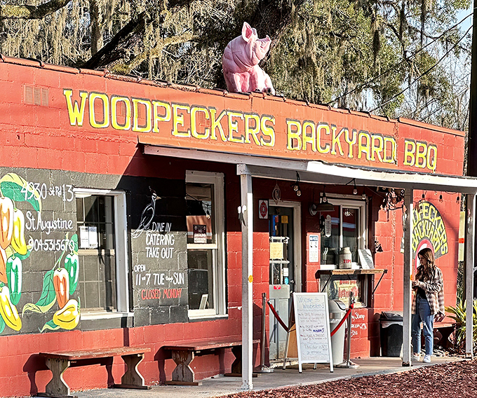Welcome to BBQ paradise! This little red shack with its pink pig guardian is where smoky dreams come true.