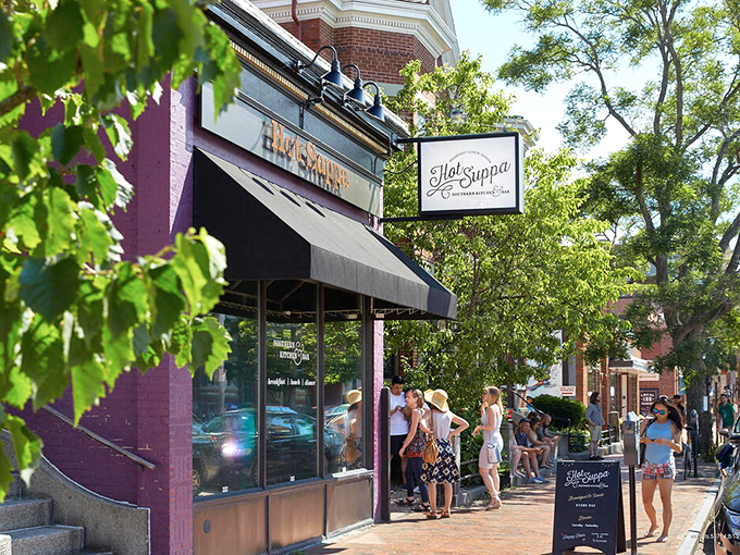 A line of eager diners stretches along Congress Street, where Hot Suppa's purple-brick facade promises breakfast dreams come true. The wait is worth every minute.