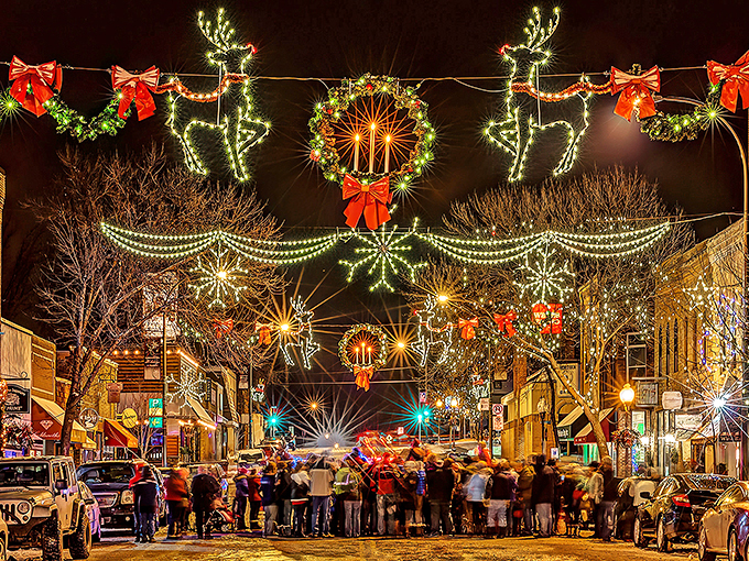 Twinkling reindeer, wreaths, and starbursts illuminate the winter sky, creating a magical Christmas atmosphere in Hudson's charming small town.