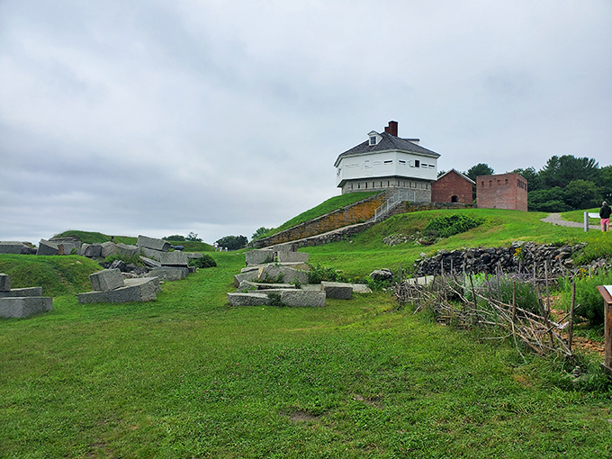 A postcard-perfect scene: Fort McClary's white buildings stand sentinel over a lush greenery.
