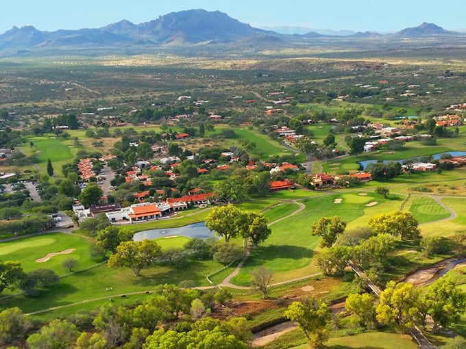 Where the desert decides to show off its green side. This aerial view captures the town's lush golf courses nestled against rugged mountains, like nature's own country club.