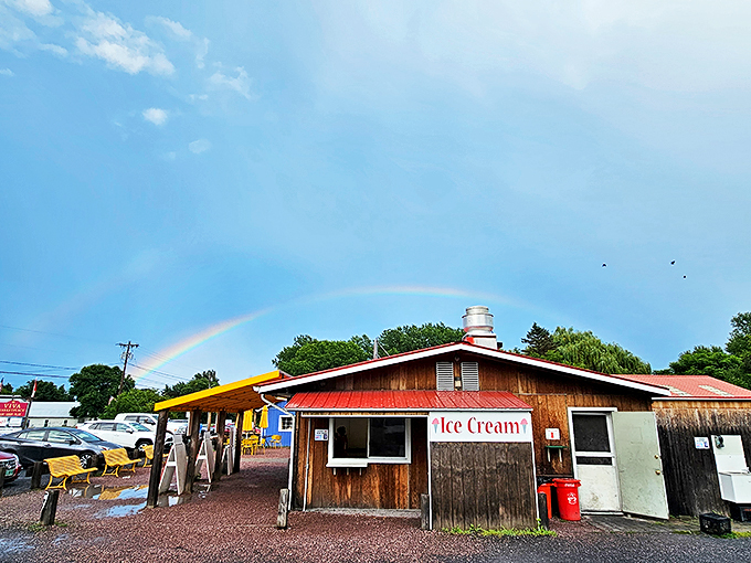 A rainbow leads the way to this charming wooden snack shack, where Vermont's sweetest treasures await beneath a rustic red roof.