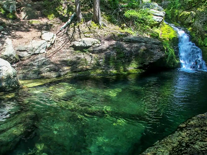 Nature's own infinity pool beckons with crystalline waters and a cascading waterfall, creating Maine's most enchanting swimming hole.