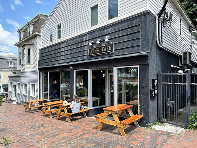 A slice of Latin American warmth nestled in Portland's brick-lined streets, Quiero Cafe's inviting facade and wooden picnic tables beckon passersby.