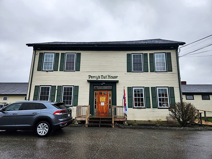 A charming colonial-style building in cream and forest green stands proudly on Route 1, beckoning sweet-toothed travelers like a lighthouse for candy lovers.