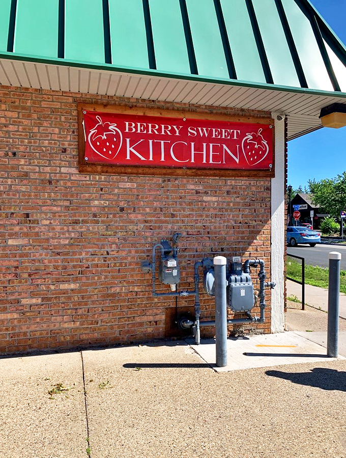 Welcome to Berry Sweet Kitchen, where the sign promises strawberries but delivers a world of flavor! This unassuming brick facade hides culinary treasures that'll make your taste buds do the cha-cha.