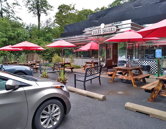 Welcome to Bob's Diner, where the red umbrellas beckon like beacons of breakfast bliss. This classic chrome-trimmed facade promises a journey back to simpler times and heartier appetites.