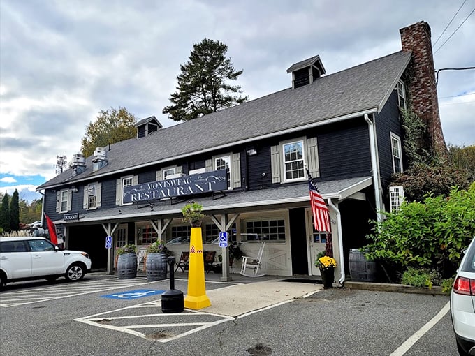 A charming New England landmark dressed in navy blue, where rocking chairs and wine barrels invite you to slow down and stay awhile.