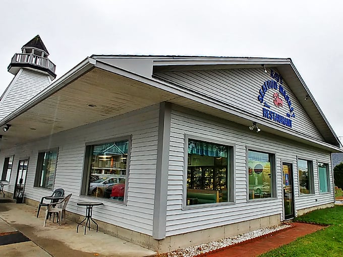 A lighthouse-inspired beacon of seafood excellence stands proudly in Essex Junction, where the white clapboard exterior promises maritime delights within.