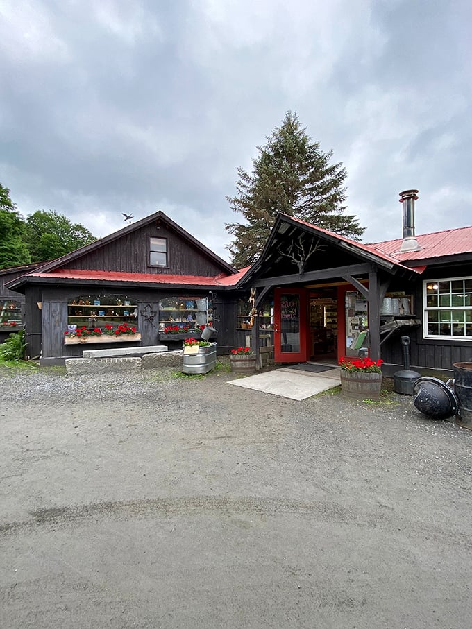 A charming Vermont sugar shack that looks like it jumped straight out of a Hallmark movie, complete with rustic charm and welcoming flowers.