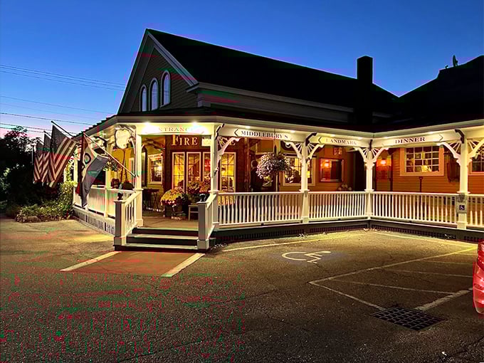 A warm Vermont welcome awaits at Fire & Ice, where the wraparound porch and glowing windows promise comfort and conversation.