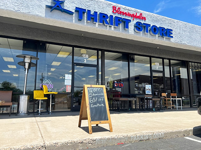 A welcoming storefront with bold blue lettering promises treasure hunting adventures, while a cheerful yellow chair beckons bargain seekers inside.