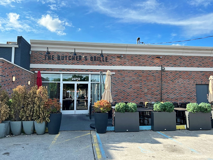 A modern brick facade with sleek planters sets the stage for culinary adventures - like a well-dressed friend who always delivers on their promises.