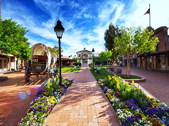 Step into a perfectly preserved slice of the Old West, complete with covered wagons and vibrant flower gardens lining brick pathways.