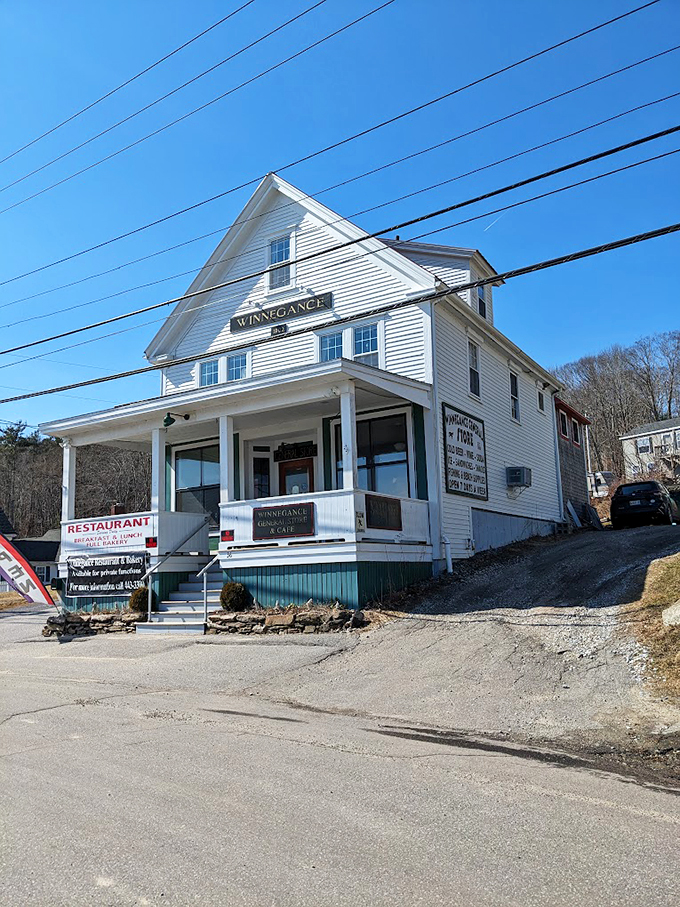 A classic New England white clapboard building stands proudly against the blue sky, promising comfort food and coastal charm within.