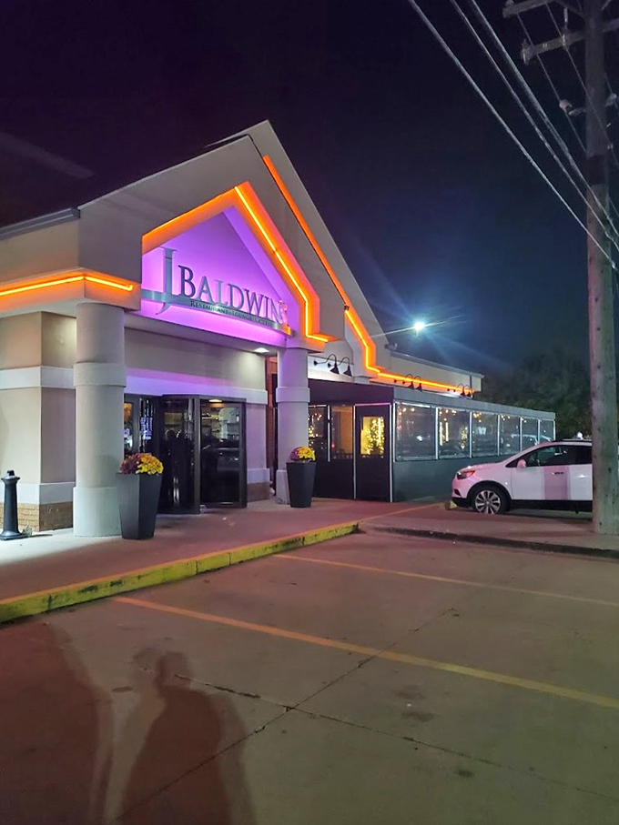 The purple and orange LED lights transform J.Baldwin's facade into a beacon of culinary promise, like a sophisticated lighthouse guiding hungry souls home.