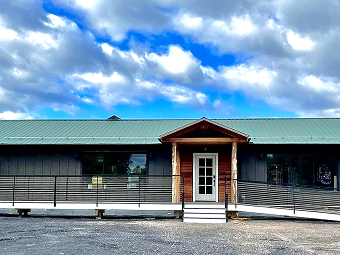 The Green Frog's modern rustic exterior welcomes visitors with its charming green metal roof and inviting wooden accents, like a cozy cabin that decided to go shopping.
