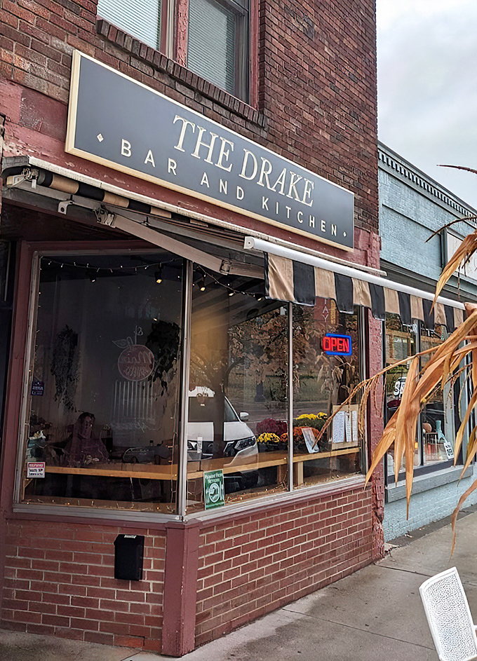 A classic brick facade in downtown St. Albans houses The Drake, where comfort meets creativity behind those welcoming windows.