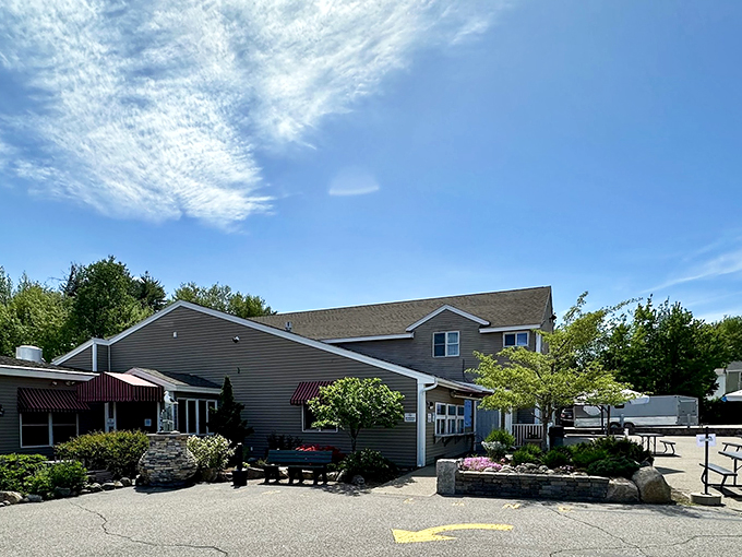 A welcoming gray-sided building with maroon awnings and well-manicured landscaping invites seafood lovers to discover Maine's coastal flavors.