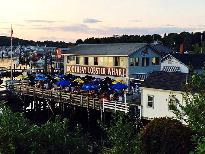 Welcome to lobster paradise! Boothbay Lobster Wharf beckons with its weathered charm and promise of oceanic delights. Those umbrellas? They're not just for show &ndash; they're beacons of buttery bliss.