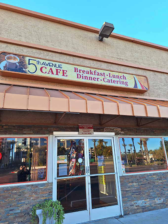 The unassuming exterior of 5th Avenue Cafe beckons with promises of home-style comfort, while palm trees wave a welcome in the Arizona breeze. Photo credit: Neil Lopez