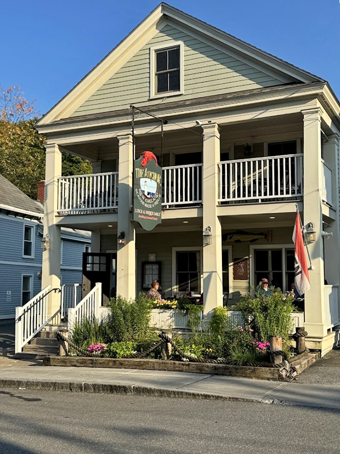 A charming yellow colonial-style building welcomes diners with its wraparound porch and vibrant flower gardens. Pure New England charm in downtown Wilmington.