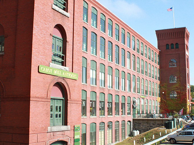 The iconic red brick Cabot Mill stands proud against the Maine sky, its green-trimmed windows telling stories of industrial heritage transformed into treasure-hunting paradise.