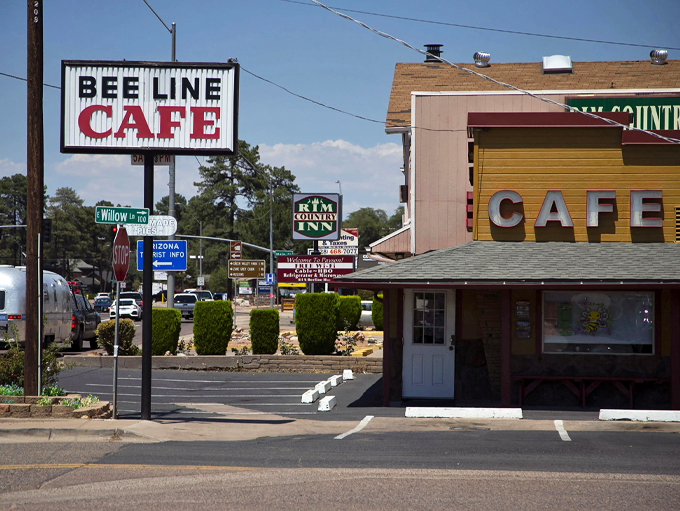 Welcome to flavor town! The Beeline Cafe's retro sign beckons like a neon lighthouse, guiding hungry travelers to a oasis of comfort food. Photo credit: The Arizona Republic