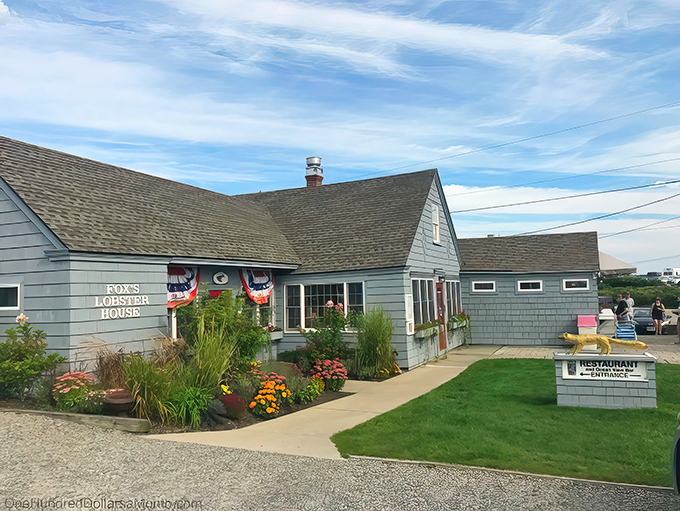 A coastal charmer that's more inviting than a warm lobster roll on a chilly day. Fox's Lobster House beckons with its quaint exterior and vibrant flower beds, promising seafood delights within.