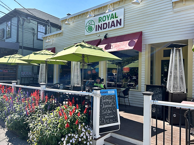 A cheerful yellow exterior with lime-green umbrellas welcomes you like a sunny day in Maine, complete with colorful flowers adding their own spicy pop. Photo credit: William Procko