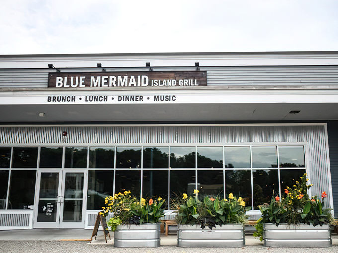 The Blue Mermaid Island Grill welcomes you with cheerful flower planters and a promise of island vibes in coastal Maine. Photo credit: Blue Mermaid Island Grill