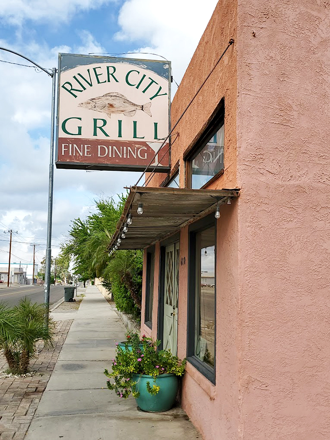 A pink oasis in the desert! River City Grill's charming facade promises a culinary adventure that's anything but beige.