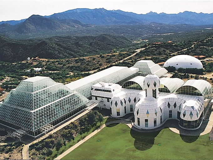 Like a sci-fi movie set dropped into the Arizona desert, Biosphere 2's gleaming domes and pyramids create an otherworldly sight against the rugged Catalina Mountains.