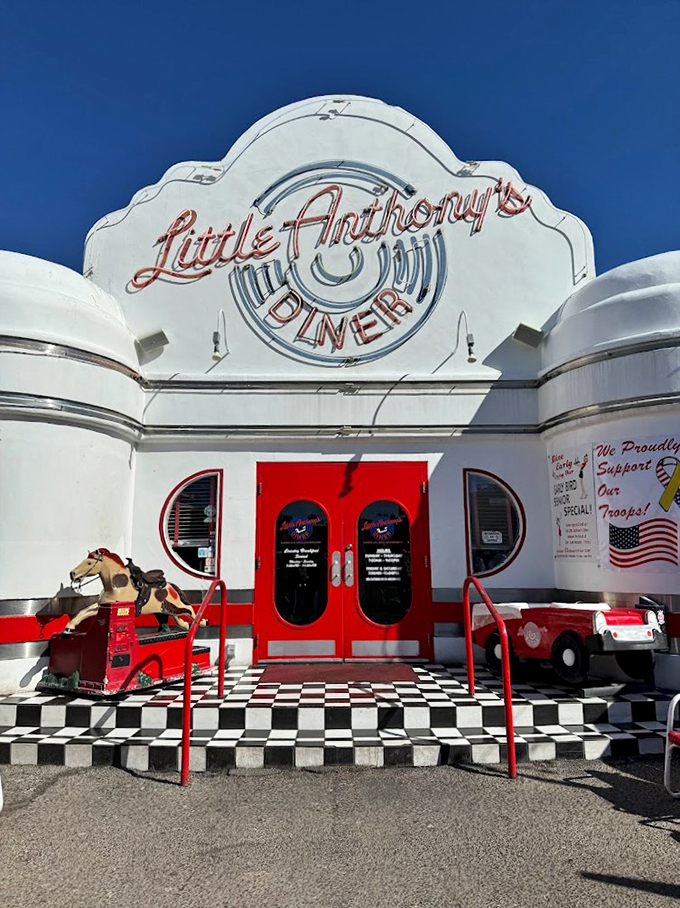 The iconic Art Deco facade of Little Anthony's gleams white against the Tucson sky, complete with checkerboard steps and vintage-style signage.