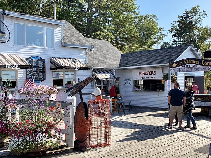 A charming white clapboard building adorned with colorful flowers welcomes visitors to this coastal gem, where seafood dreams come true. Photo credit: Betsy W.