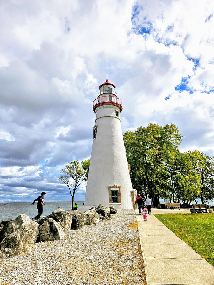 A postcard come to life! The Marblehead Lighthouse stands tall, its white tower a beacon of hope against the cloudy sky.