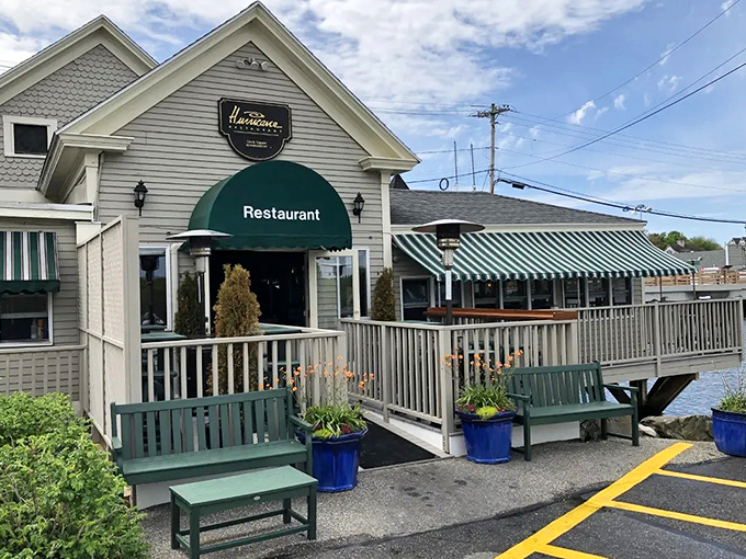 A classic New England welcome awaits at Hurricane Restaurant, where white clapboard and green trim create the perfect coastal dining setting. Photo credit: Sea Coast Online