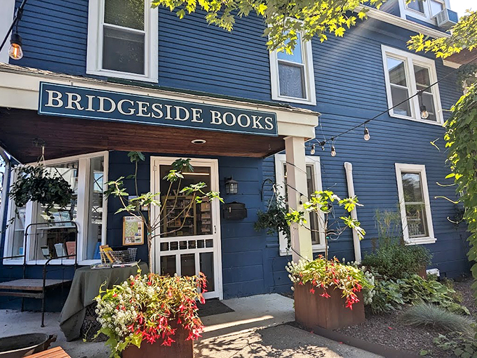 Welcome to Bridgeside Books, where literary dreams come true! This charming blue facade is like a portal to countless worlds, all waiting to be explored. 