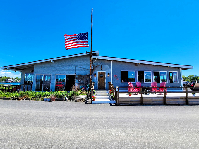 A classic Maine seafood spot with weathered gray shingles and bright red Adirondack chairs - like a Norman Rockwell painting come to life.