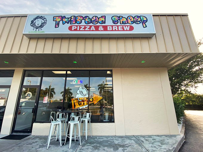 A whimsical storefront that proves great pizza can hide in plain sight. The playful sheep logo sets the tone for the creative culinary adventure within.