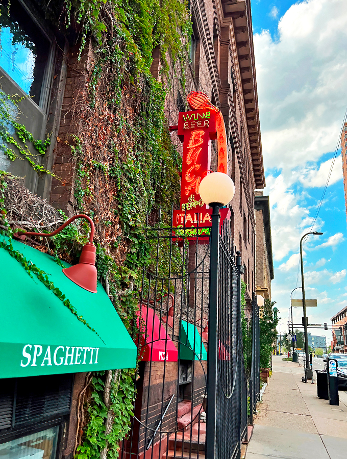 Mama mia! This brick facade isn't just a wall &ndash; it's a portal to pasta paradise. Red awnings and ivy whisper promises of cozy Italian feasts within.