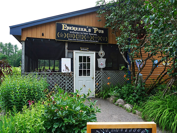A charming wooden exterior welcomes you to Ebenezer's Pub, where flowering gardens and latticed walls create Maine's coziest beer sanctuary. Photo credit: Brooks